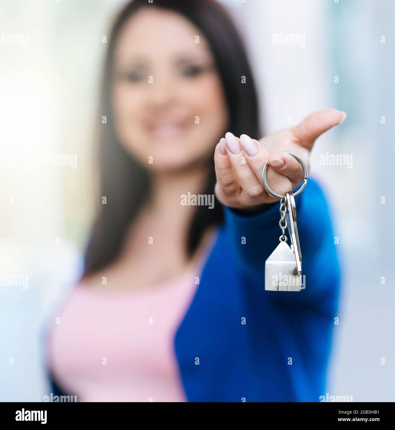 Woman agent holding out house hi-res stock photography and images - Alamy