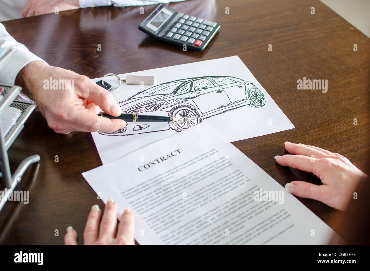Dealer showing a detail on a car design with his pen Stock Photo - Alamy