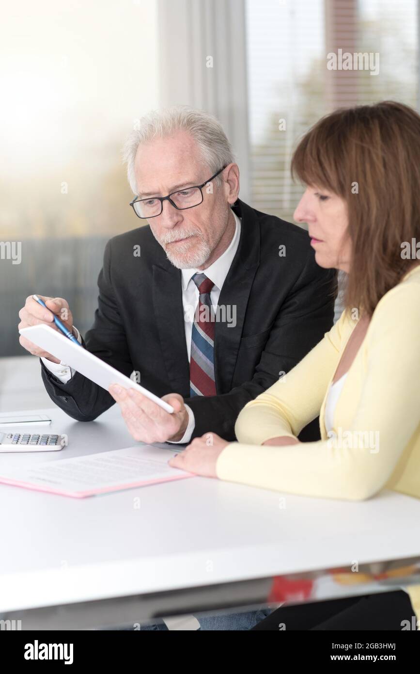 Financial consultant giving advices to female client, light effect ...