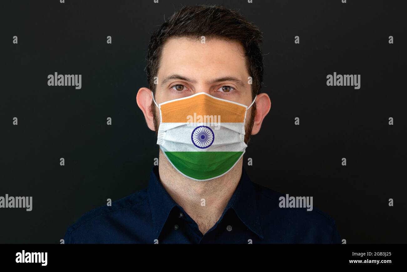 Man wearing Indian flag protective medical face mask. He looks worried ...