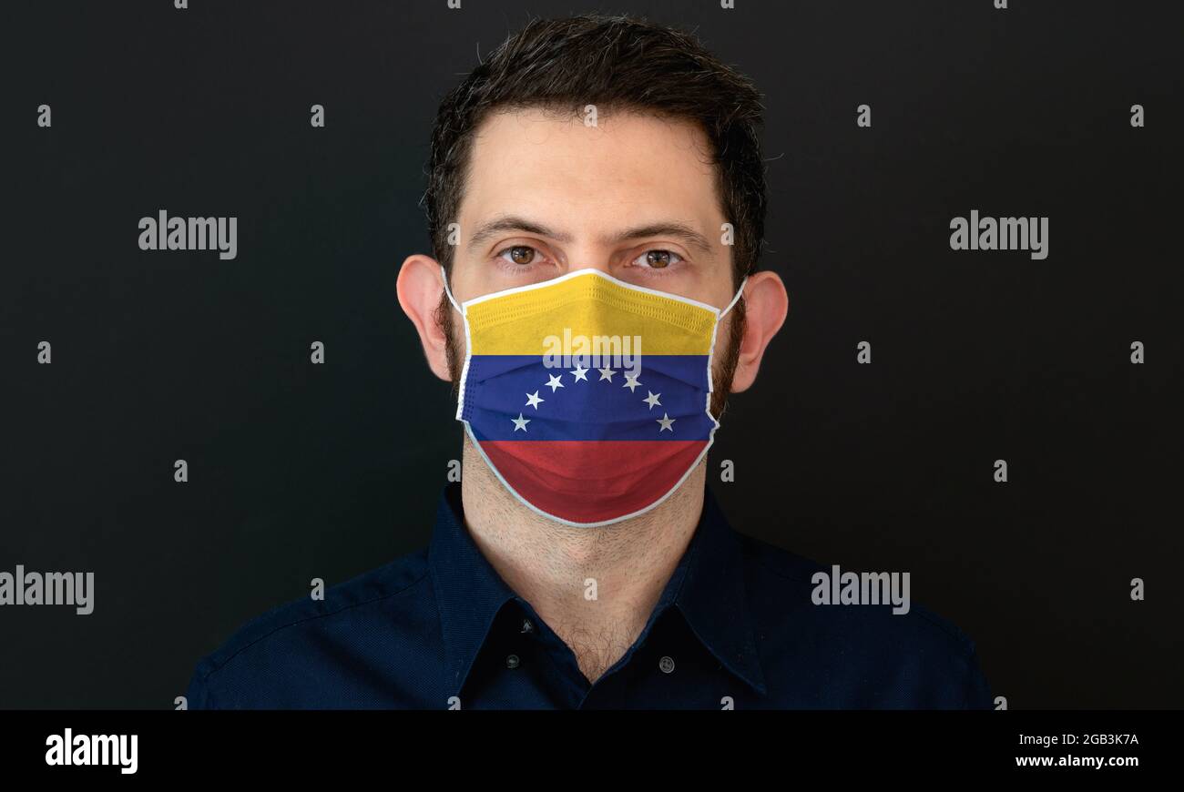 Man wearing Venezuelan flag protective medical face mask. He looks ...