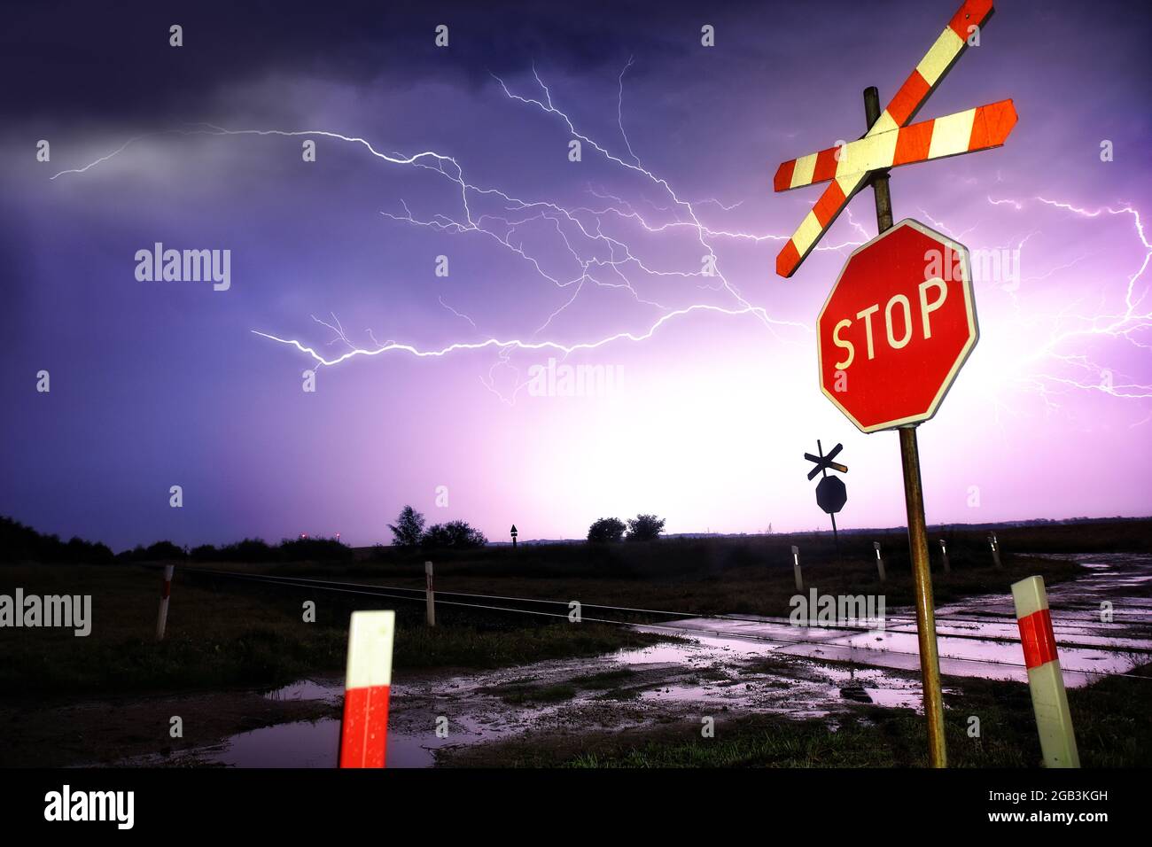night storm and railroad crossing stop sign Stock Photo - Alamy