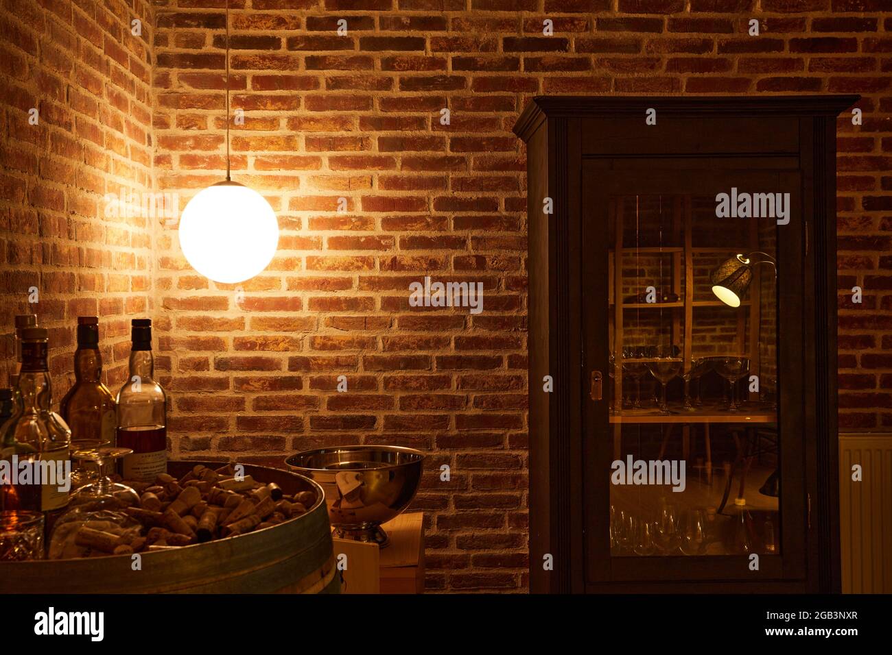 a wine basement with brick walls and dim lights Stock Photo - Alamy