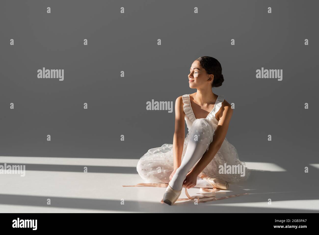 Side view of ballerina wearing pointe shoe on grey background Stock ...