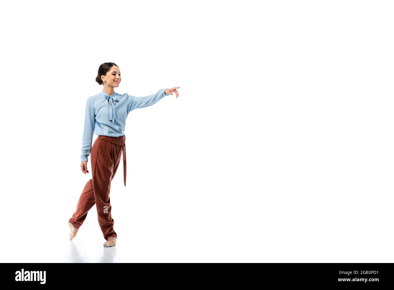 Brunette ballerina pointing with finger on white background Stock Photo ...