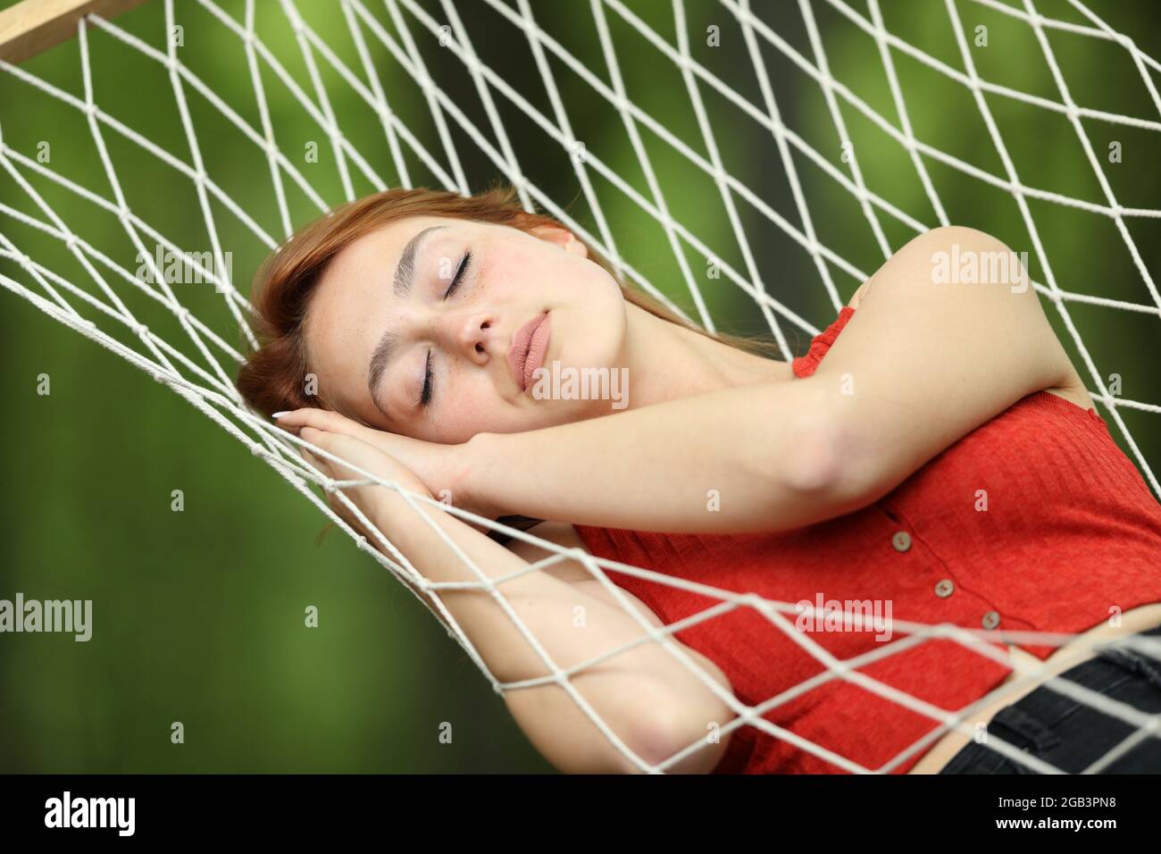 Woman relaxing sleeping on rope hammock in a garden or forest Stock ...