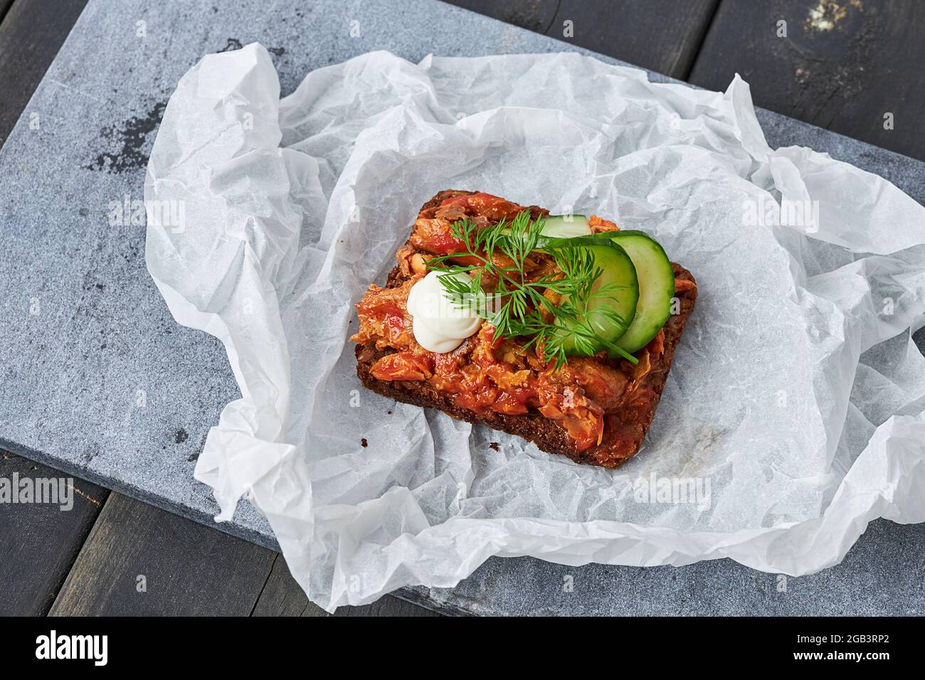 a fish lunch on bread with vegetables Stock Photo - Alamy