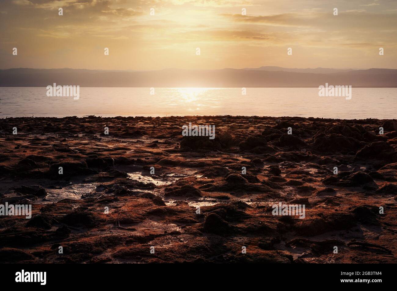 Dead Sea Salty red Mud shore in Jordan Stock Photo - Alamy