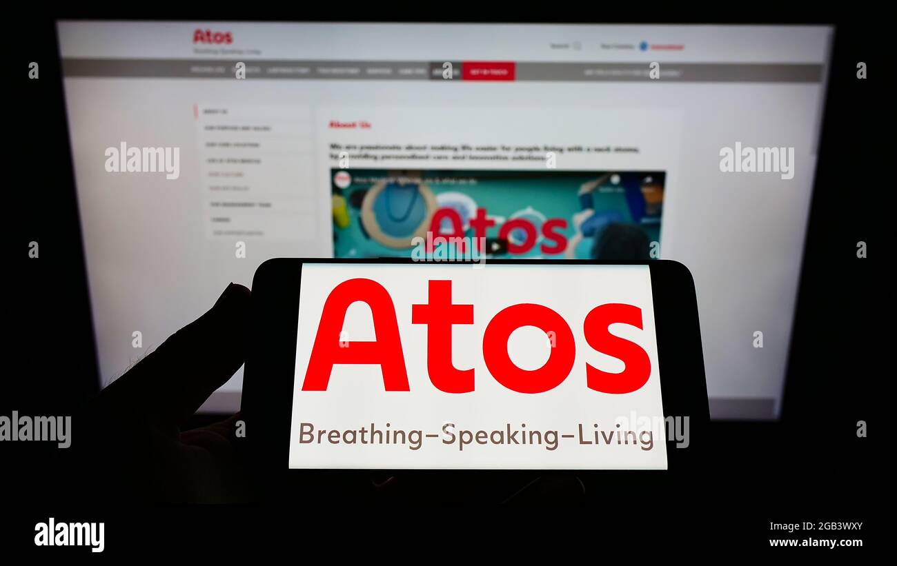 Person holding mobile phone with logo of Swedish medical technology ...