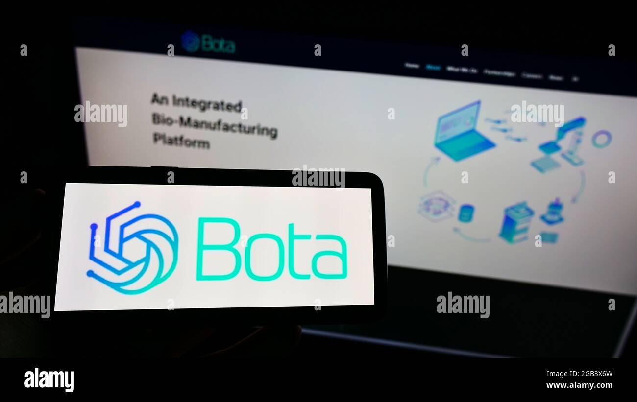 Person holding mobile phone with logo of Chinese biotechnology company ...