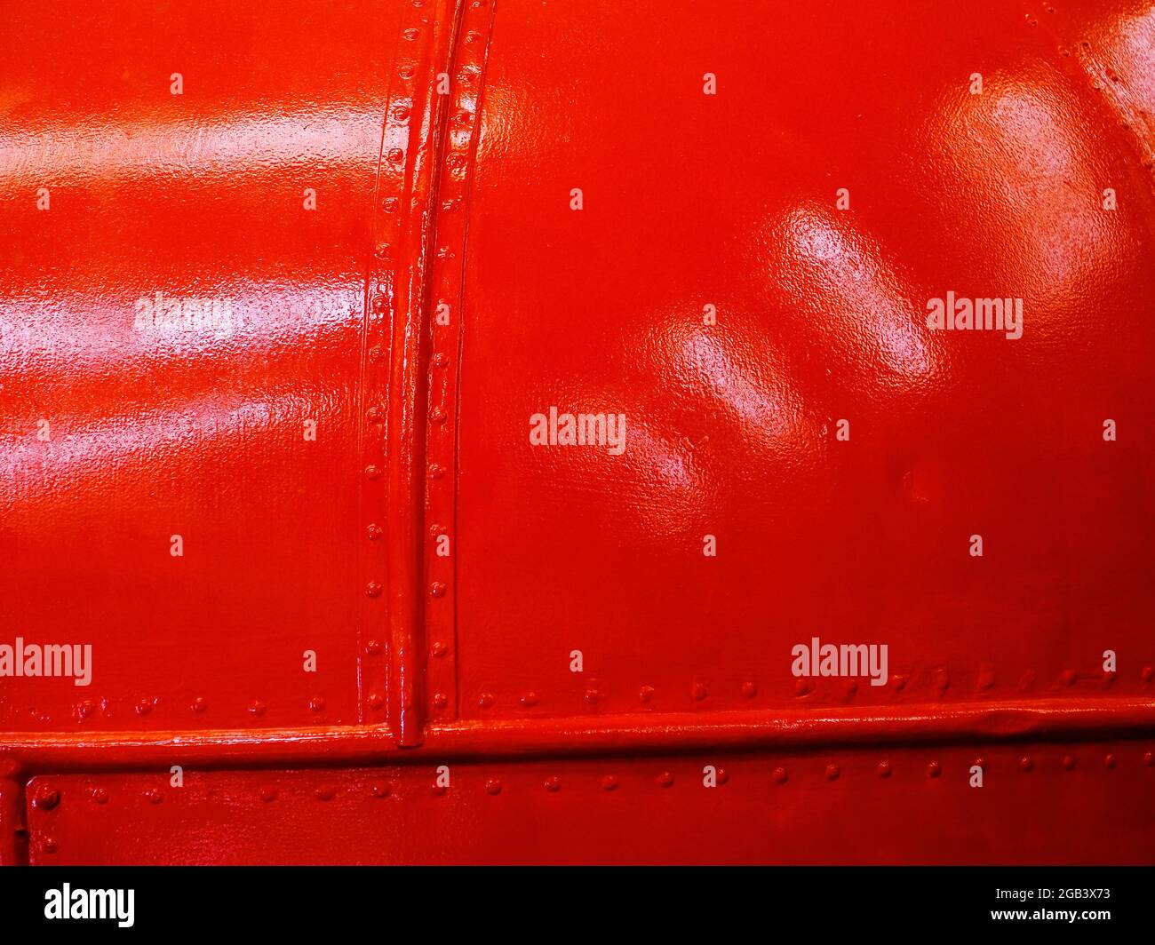 Bright red steel riveted manufactured boiler panels Stock Photo - Alamy