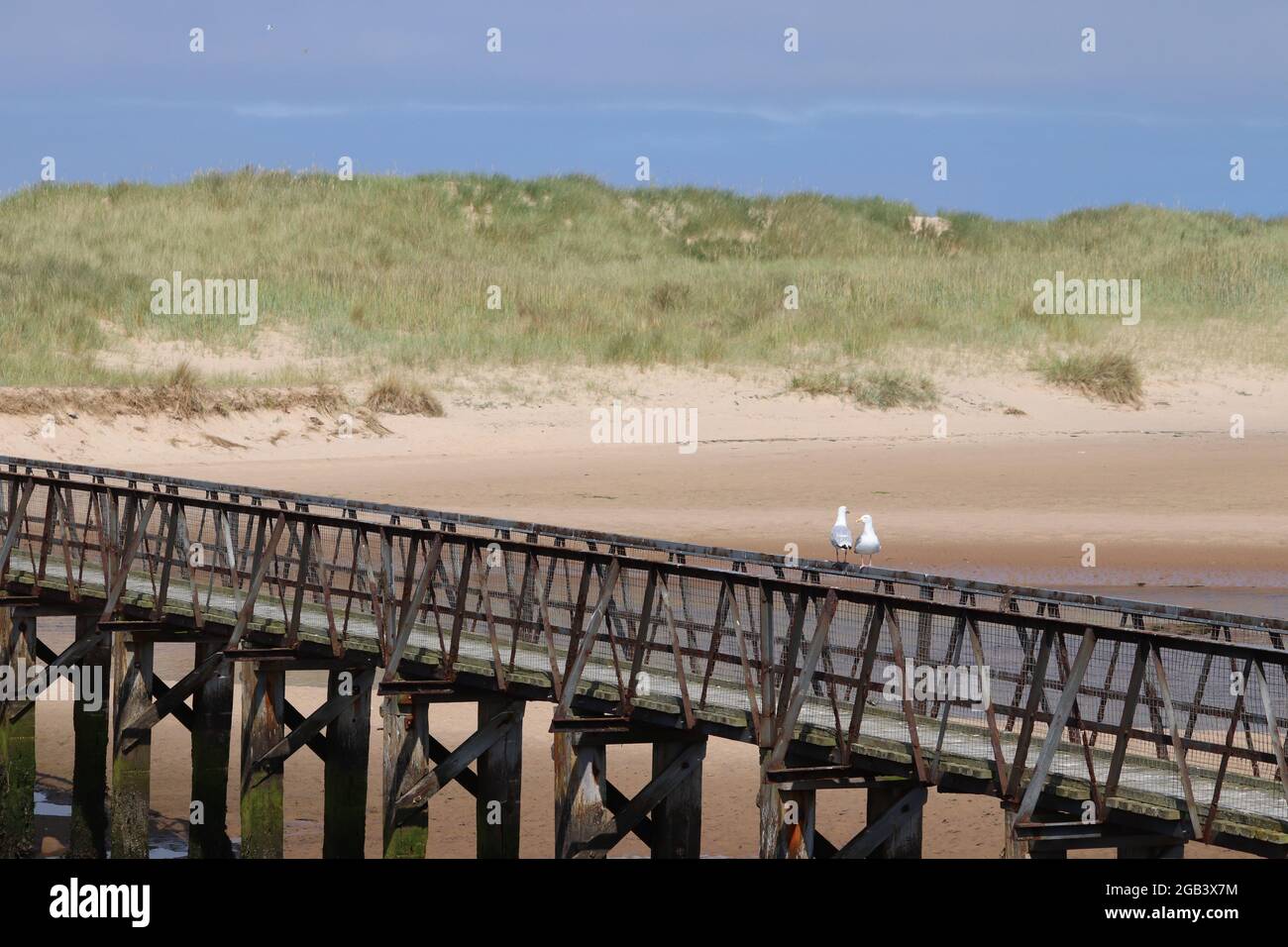 Old wooden bridge at beach Stock Photo - Alamy