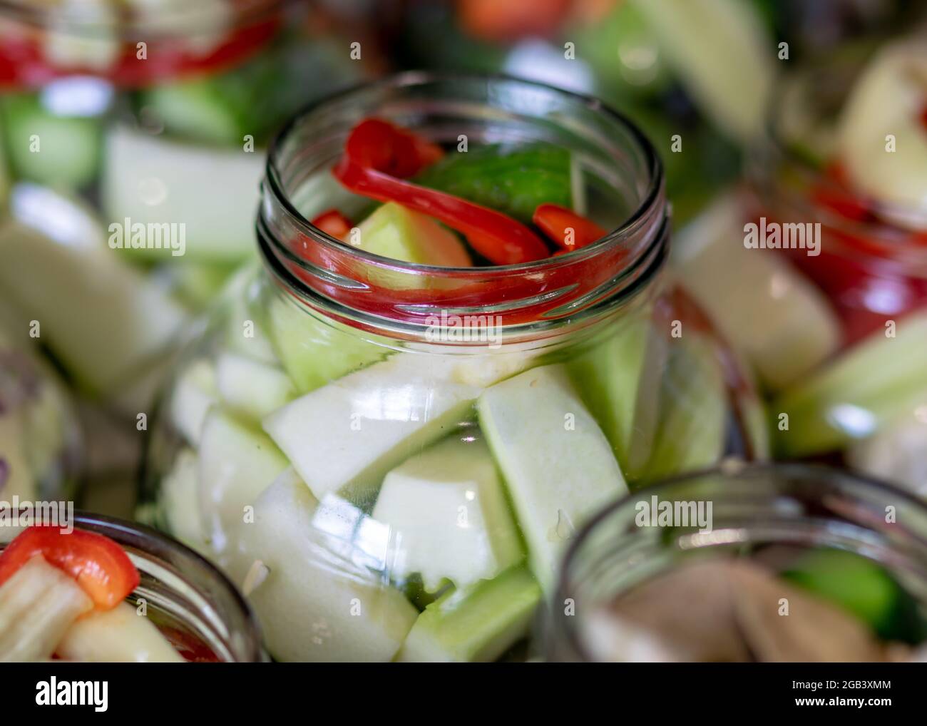 glass jars with different colors, types, shapes of vegetables ...