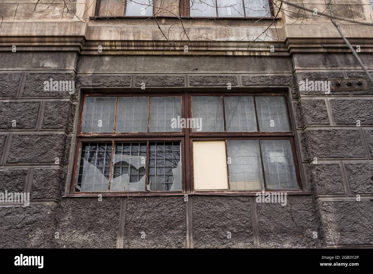 big dirty broken window. dark wall of a large house. Vintage ...