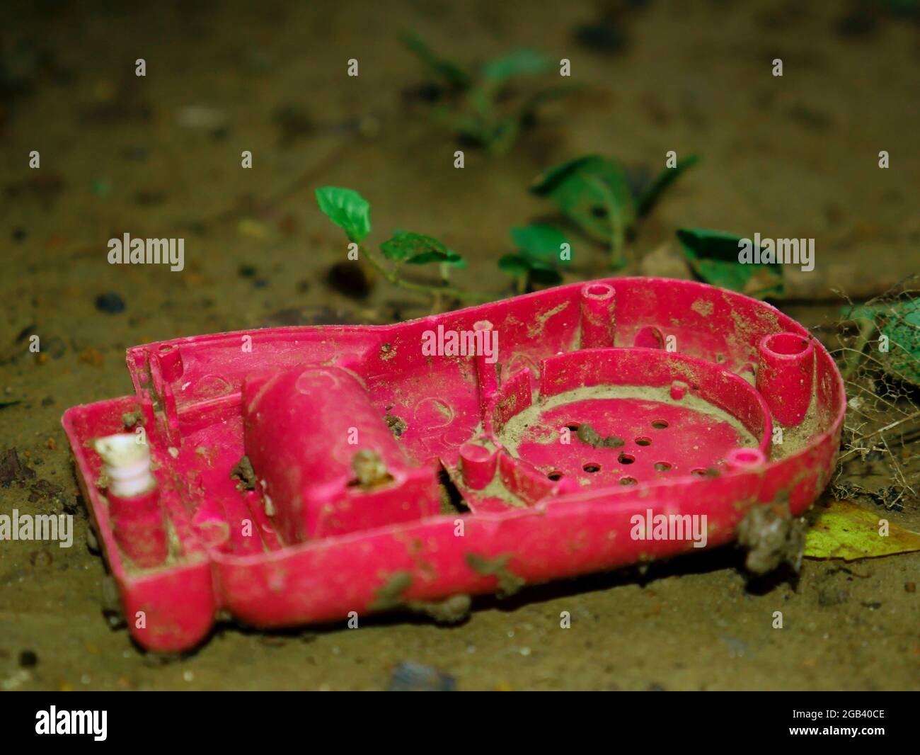 Kids toy damage lying on soil field, Nature pollution concept ...
