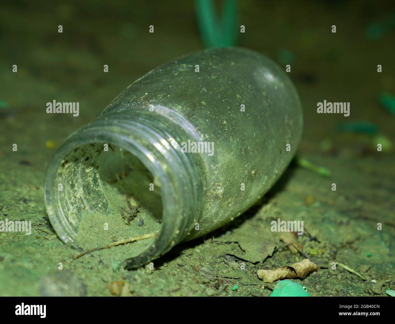 Medicated glass bottle lying on soil field, Nature pollution concept ...