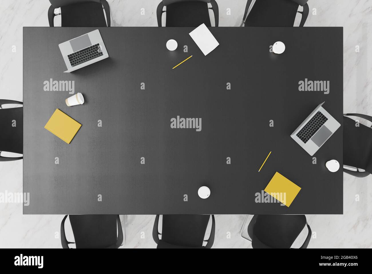 top view of an office table with chairs on the sides and books and ...