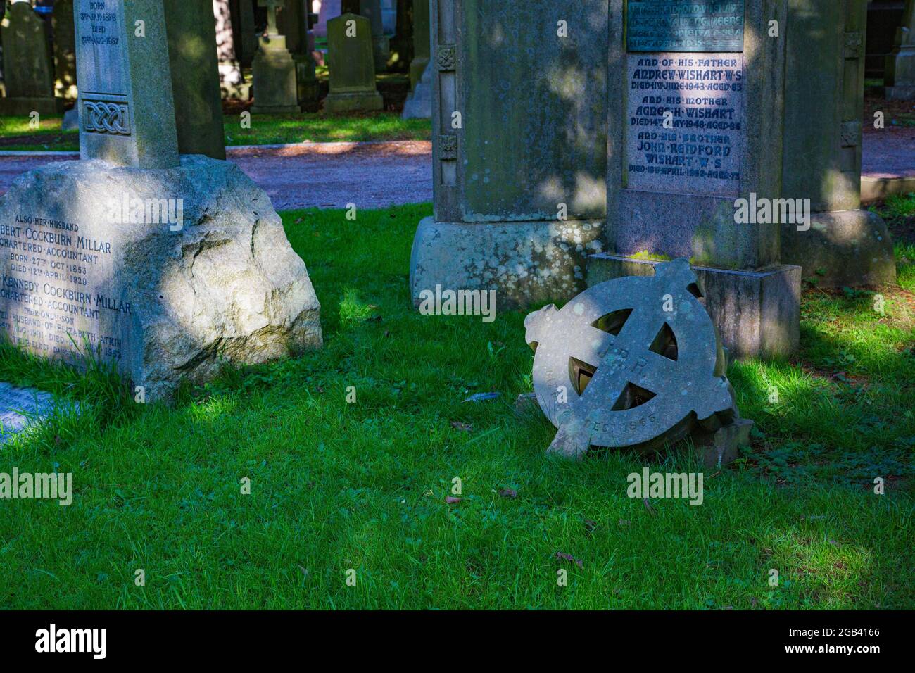 Gothic cemetery with graves in the ground and headstones in the shape ...