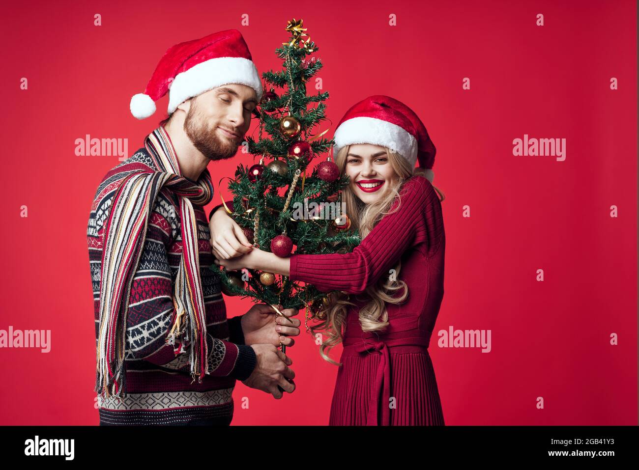 young couple christmas tree toys decoration holiday Stock Photo - Alamy