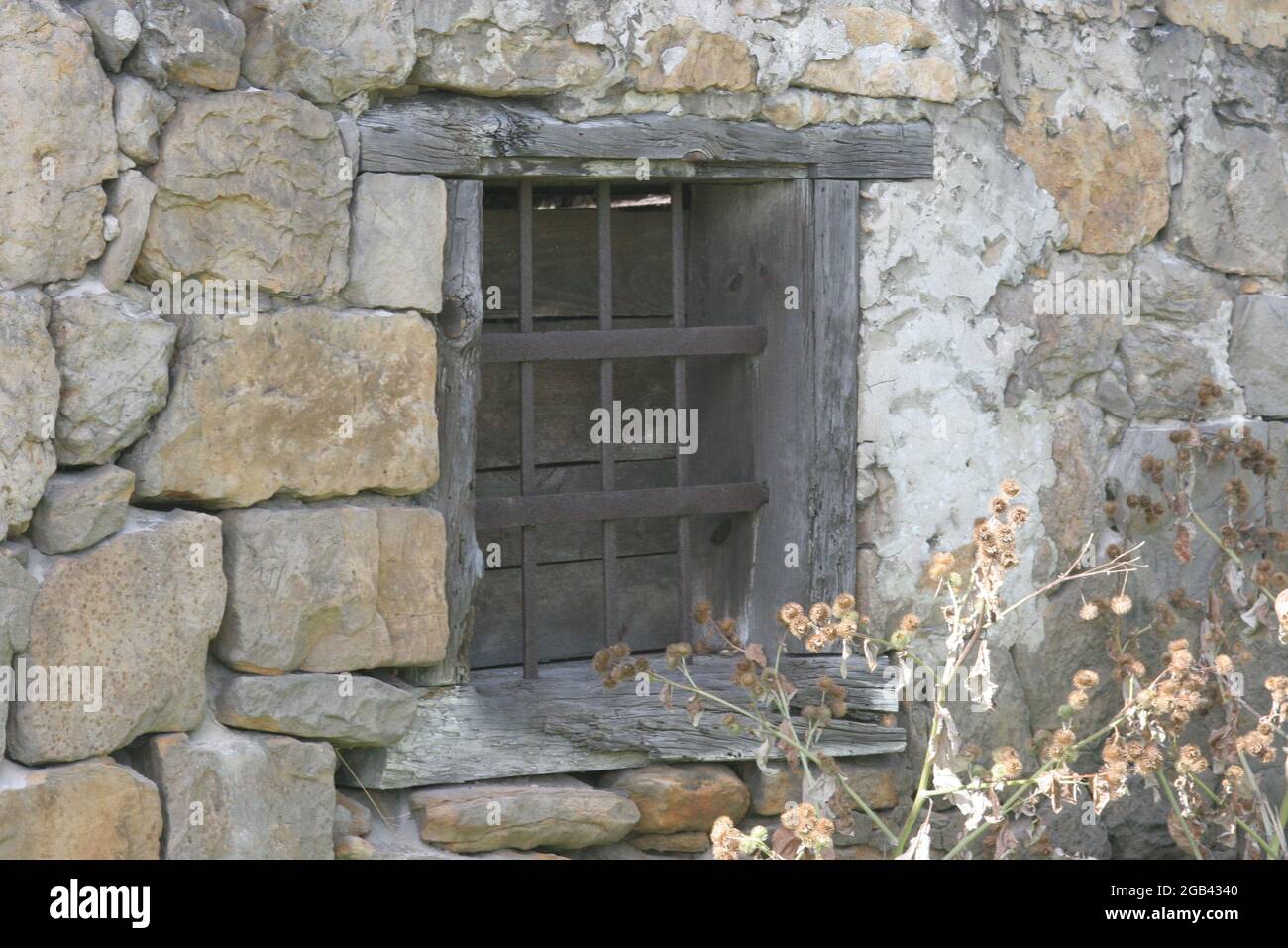 Old window with grille and stone wall Stock Photo - Alamy
