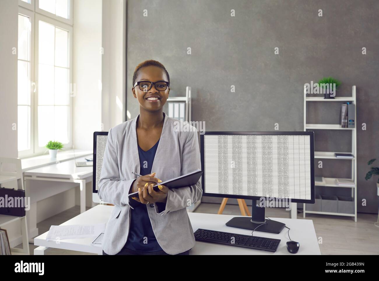 Portrait of a professional african american female manager near her ...