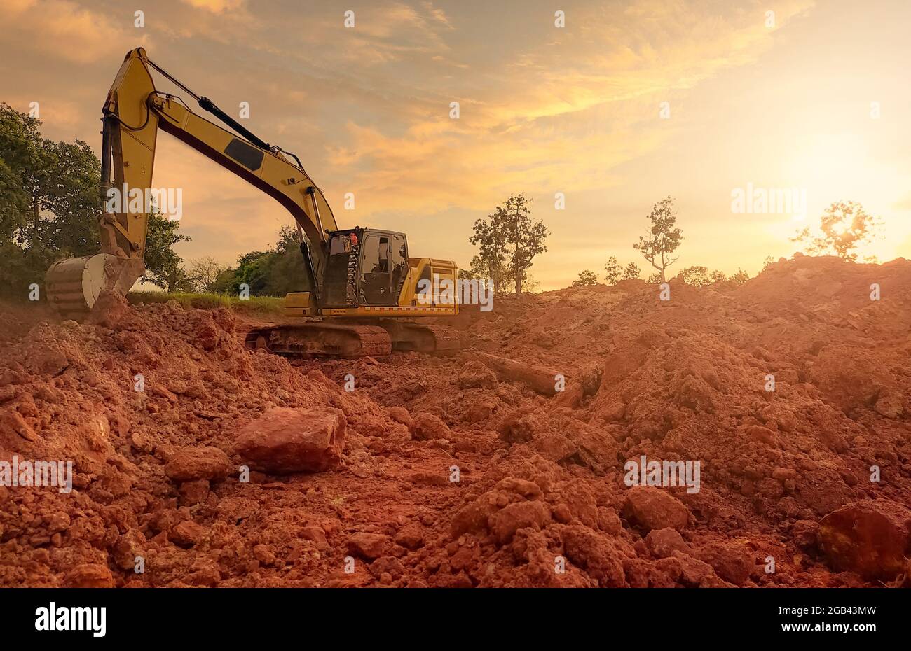 Backhoe working by digging soil at construction site. Bucket teeth of ...