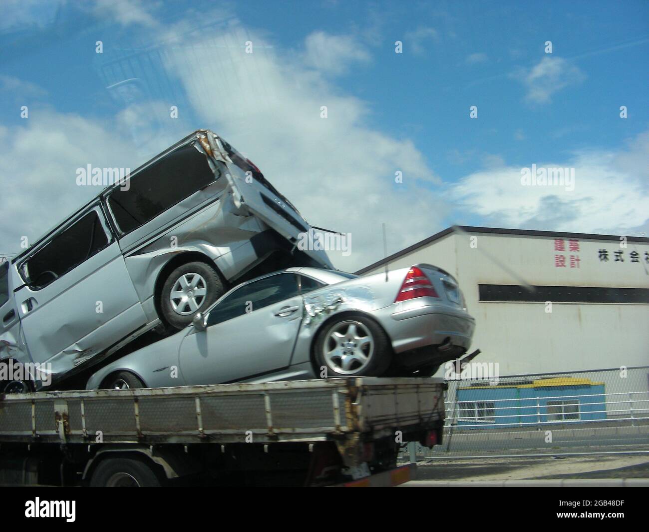 Wrecked Cars on Truck Stock Photo - Alamy