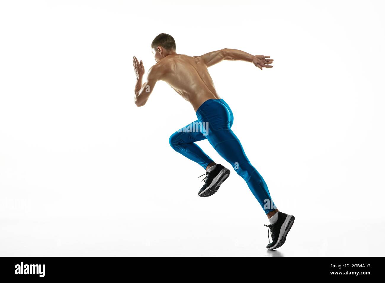 One Caucasian professional male athlete, runner training isolated on ...