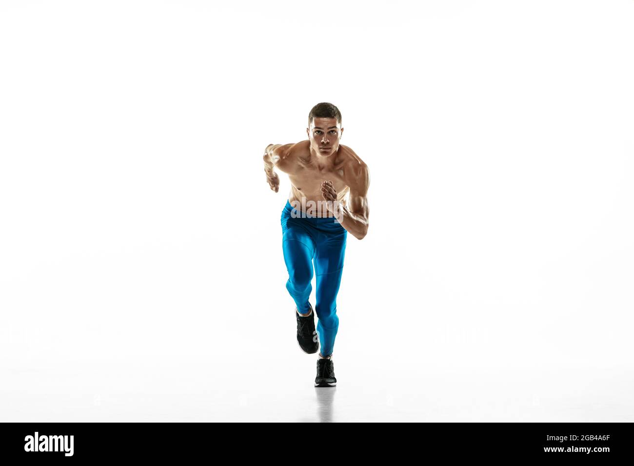 Front view of Caucasian professional male athlete, runner training ...