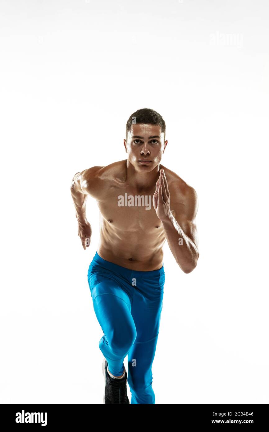 Front view of Caucasian professional male athlete, runner training ...