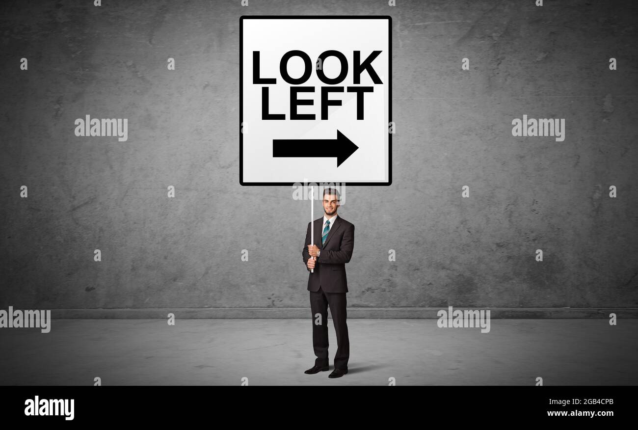 business person holding a traffic sign Stock Photo - Alamy