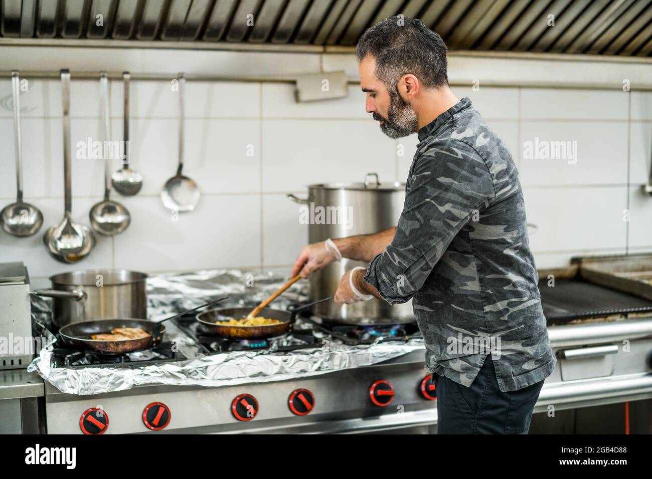 Professional chef mixing frying meat hi-res stock photography and ...