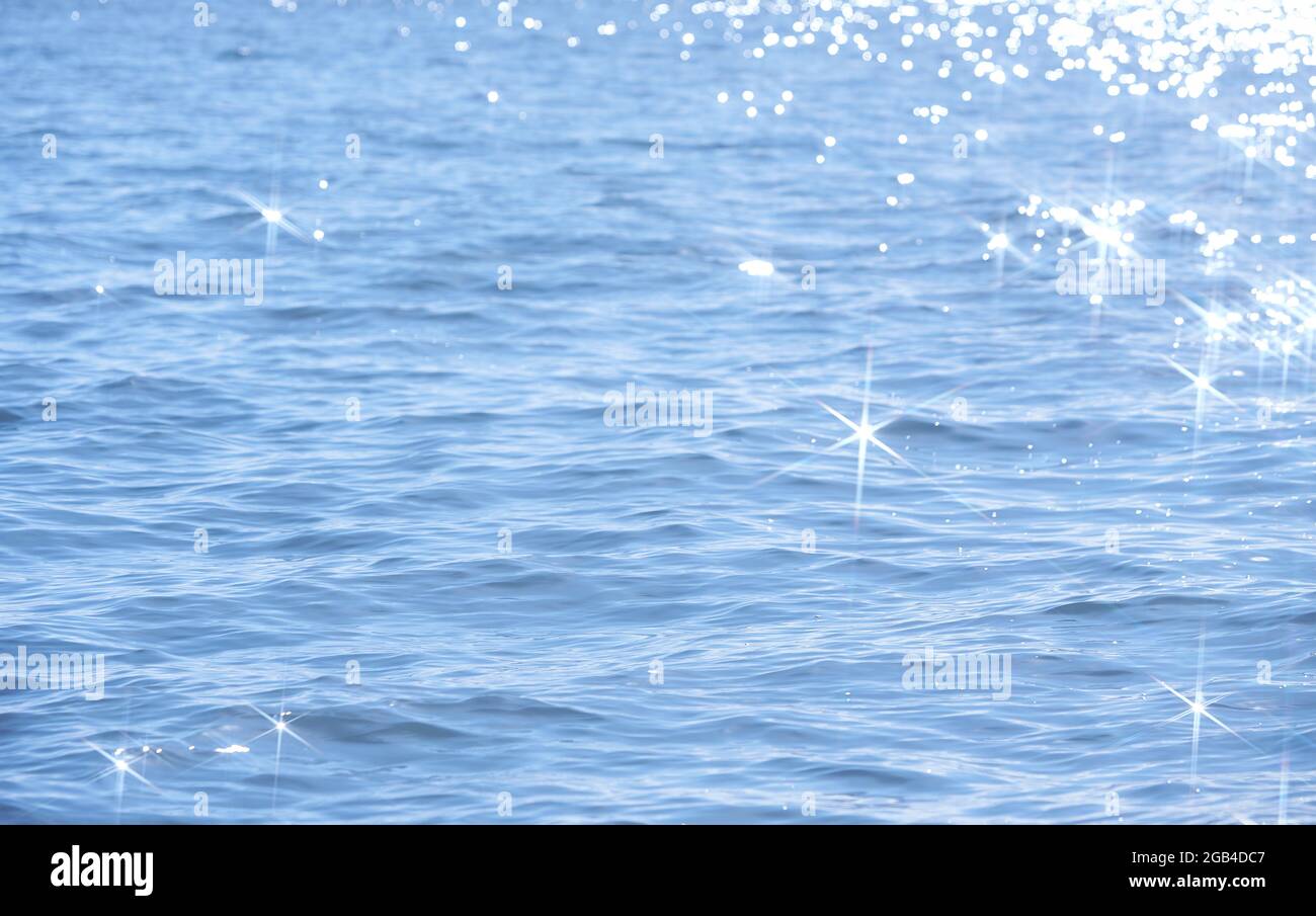 Detail of a sunlight reflecting in glittering sea. sparkler in water ...