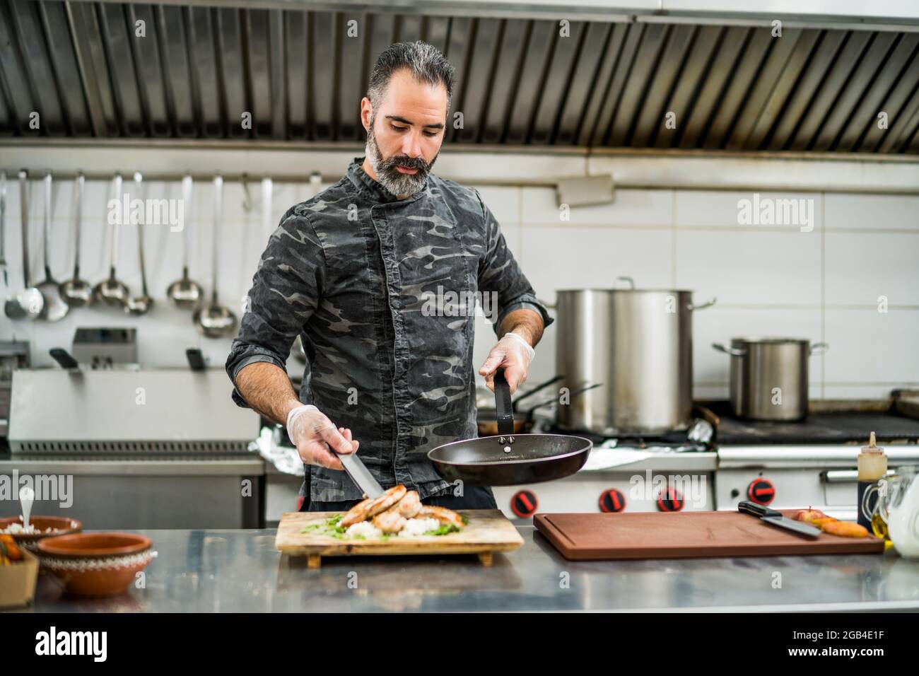 Professional cook is preparing meal in restaurant's kitchen Stock Photo ...