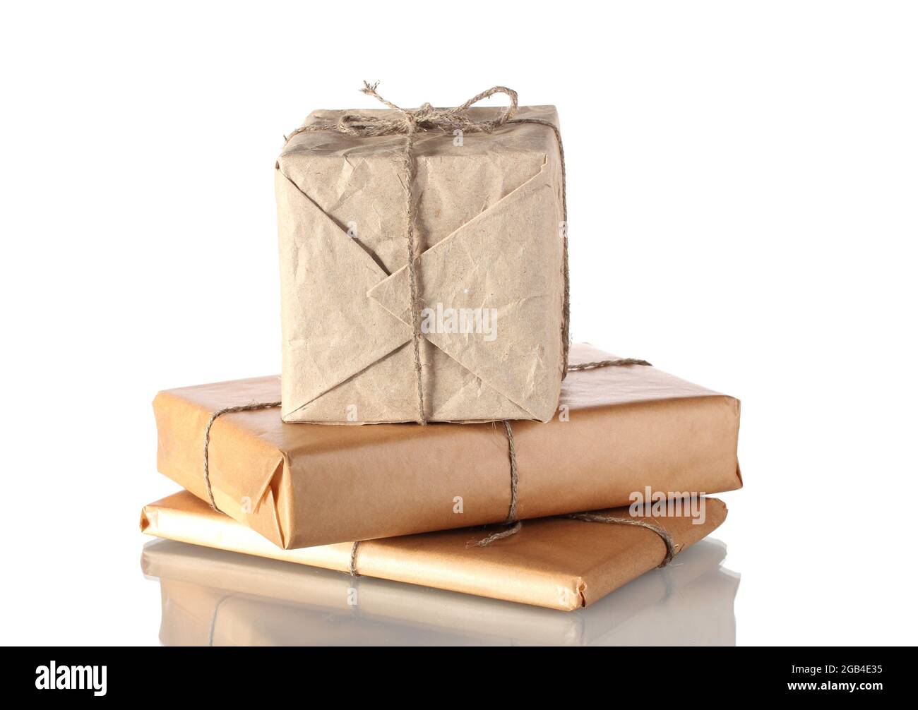 Three parcels arranged in stack isolated on white Stock Photo - Alamy