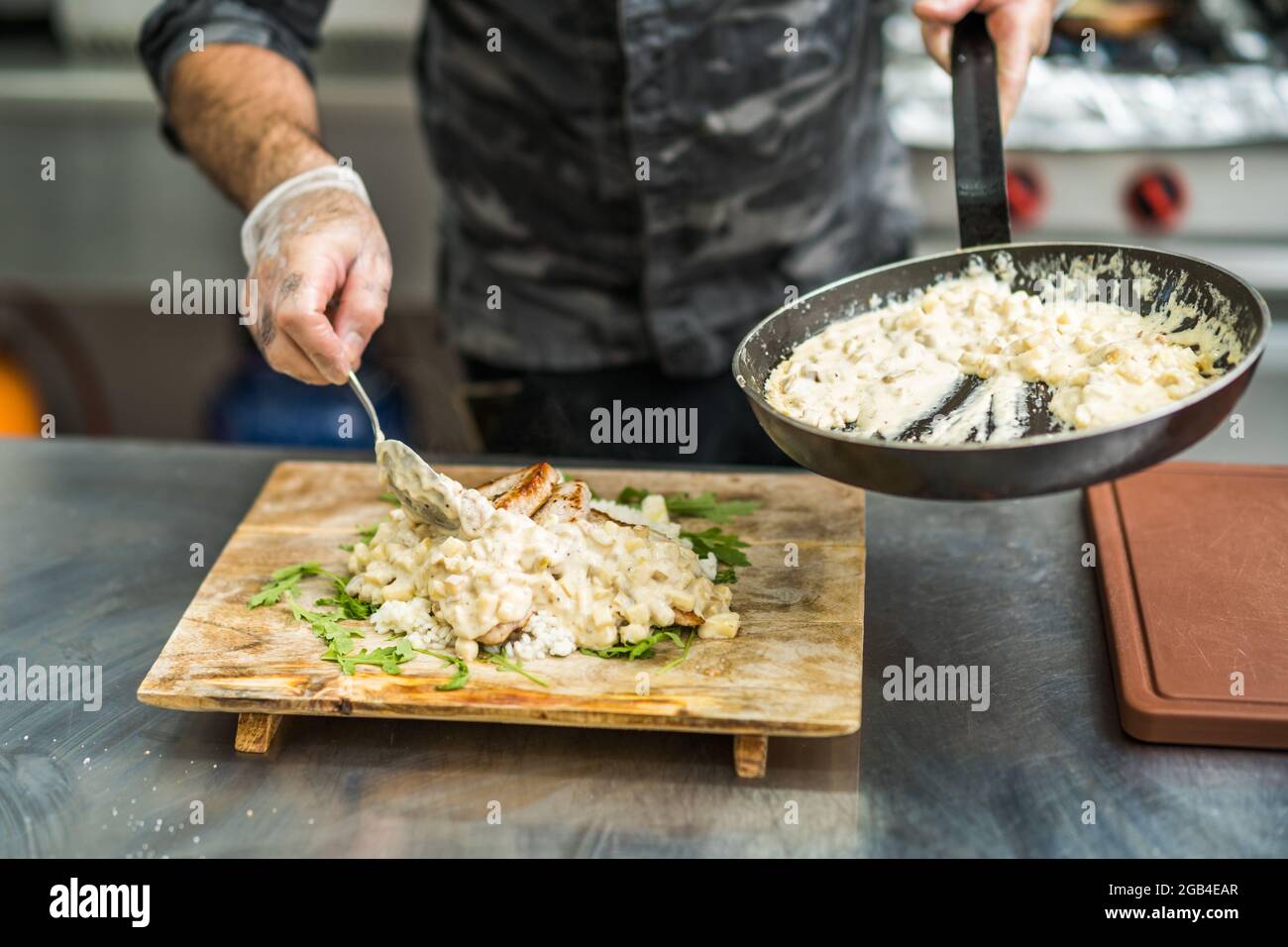 Professional cook serving meal hi-res stock photography and images - Alamy