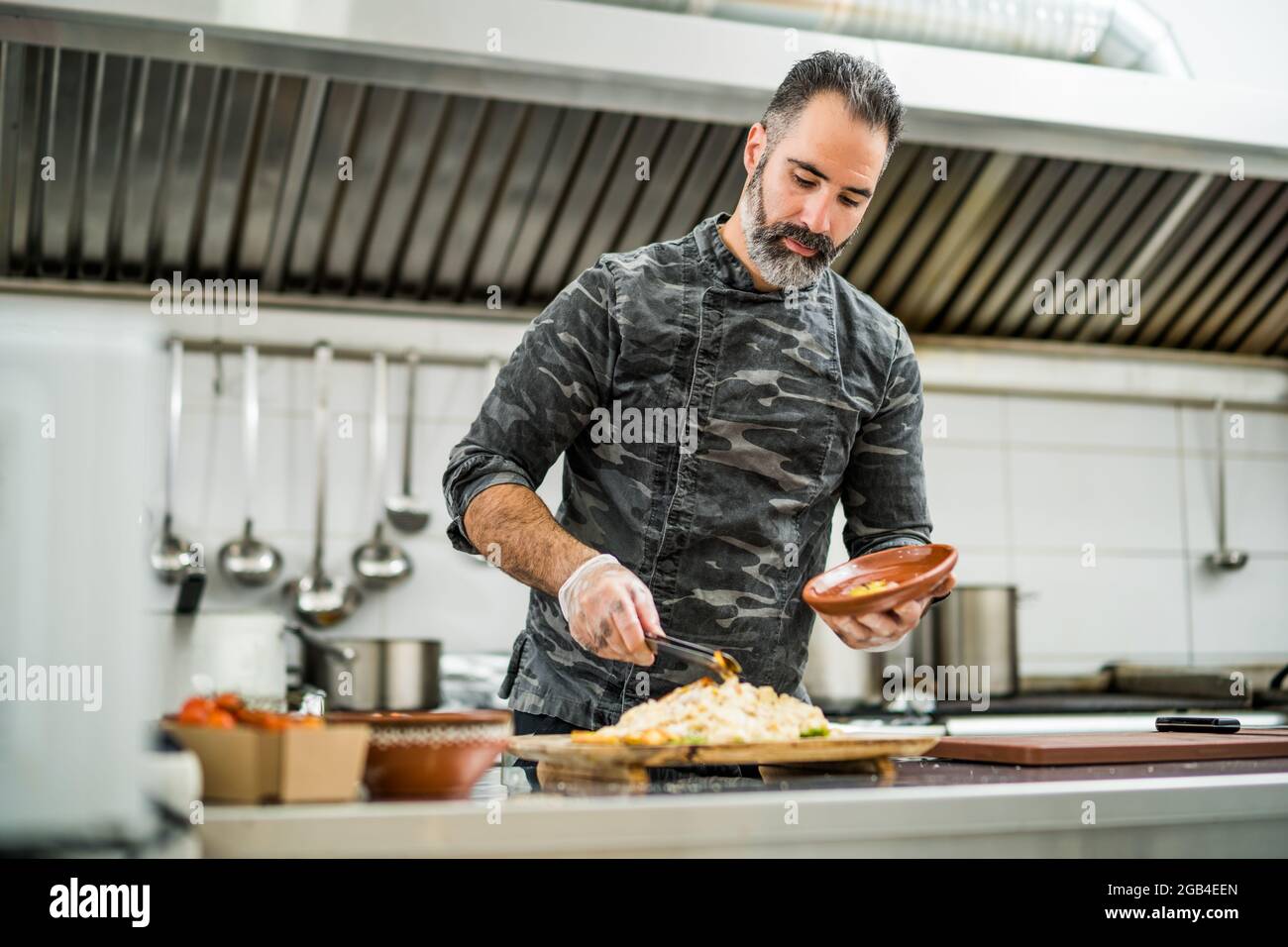 Professional cook serving meal hi-res stock photography and images - Alamy
