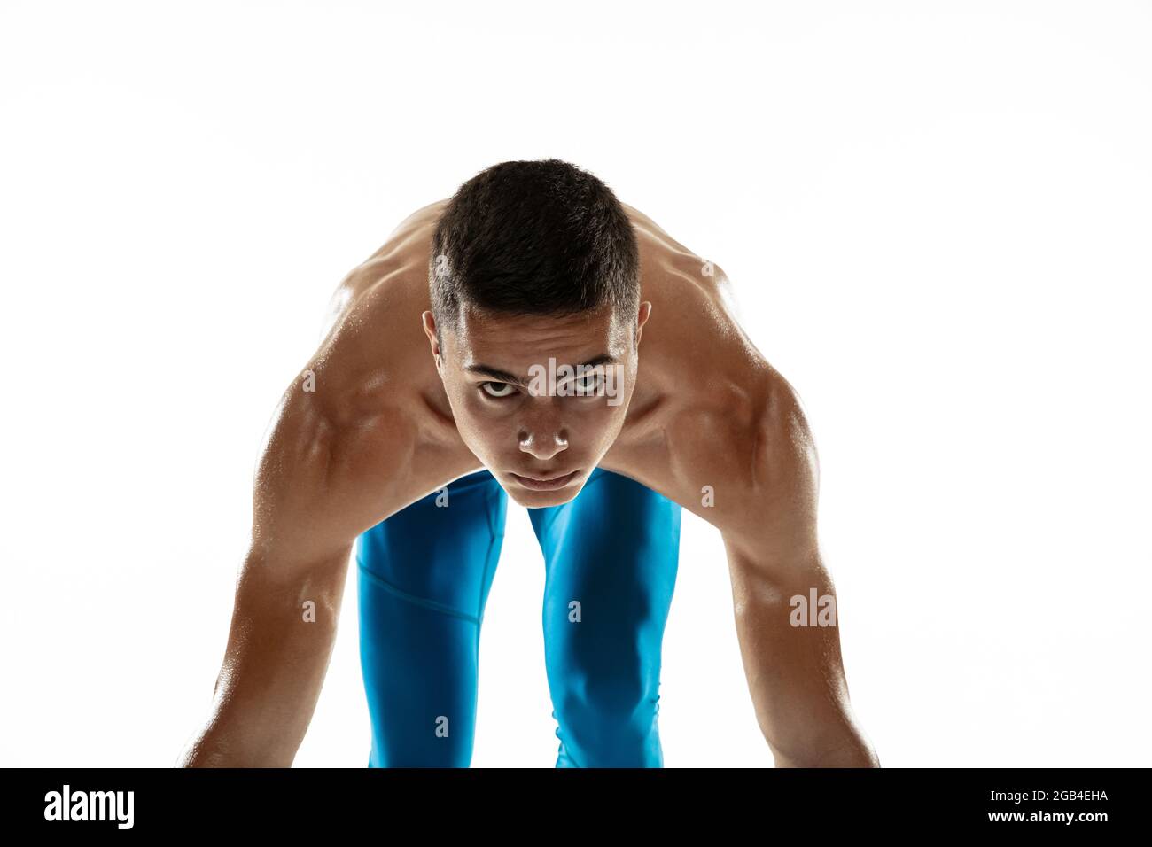 Portrait of young professional male athlete, runner isolated on white ...
