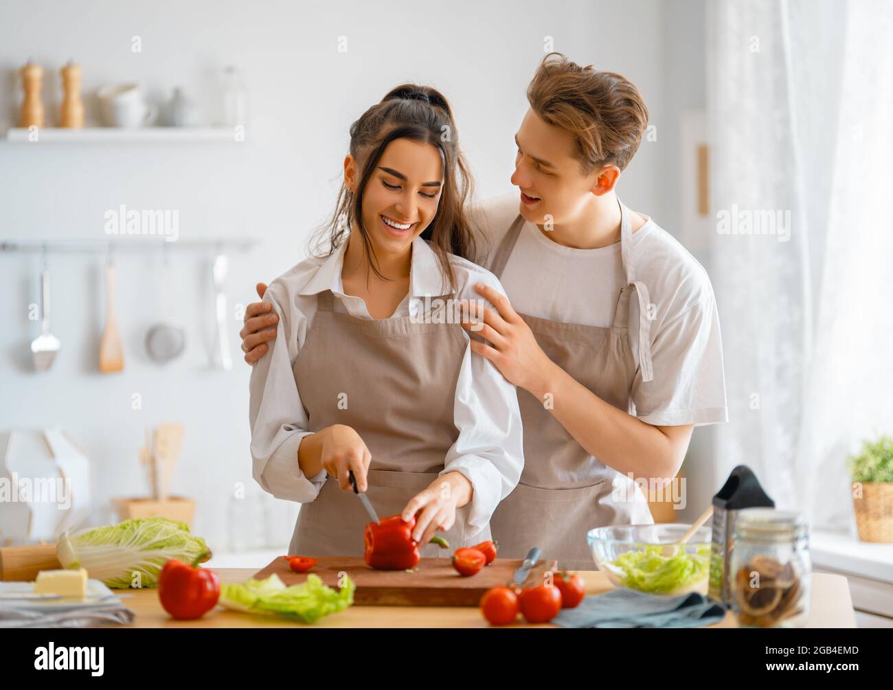 Healthy food at home. Happy loving couple is preparing the proper meal ...