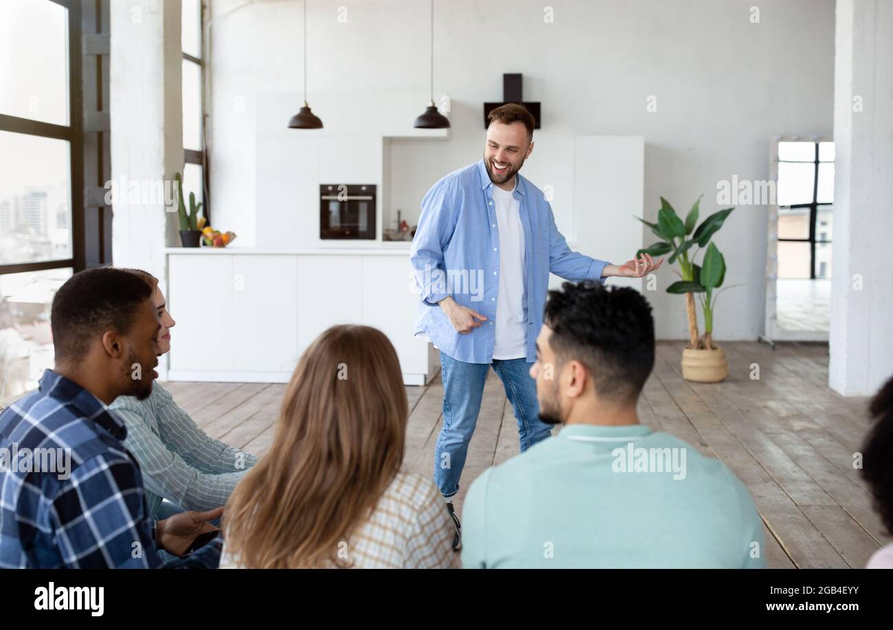 Group of international friends playing guess who game, showing ...