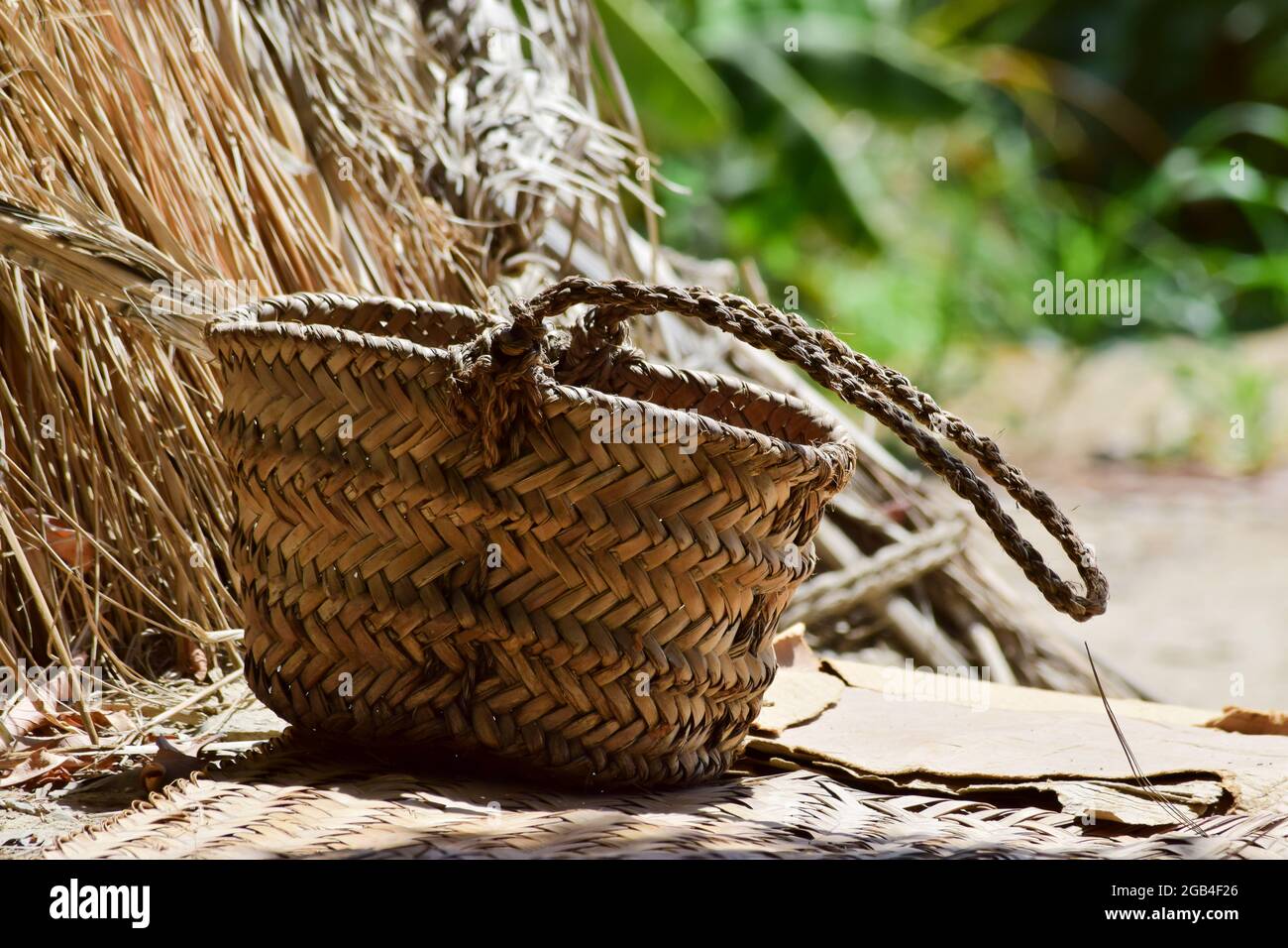 Hand made dates tree box tool, palm leaf dry jar hanging on wood in ...