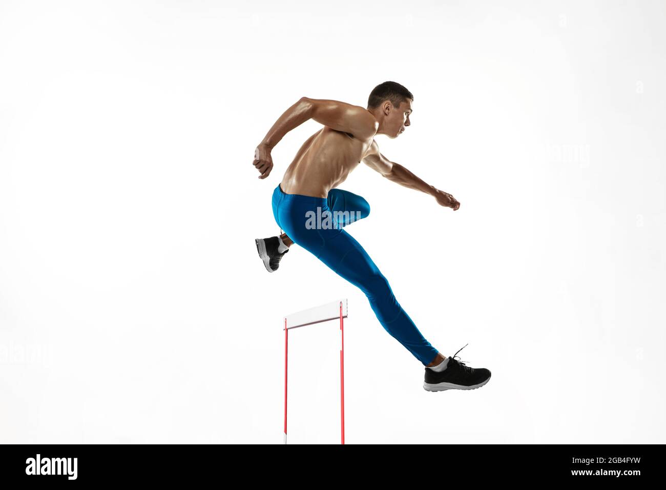 Steeplechase. Young male athlete, runner running, jumping isolated on ...