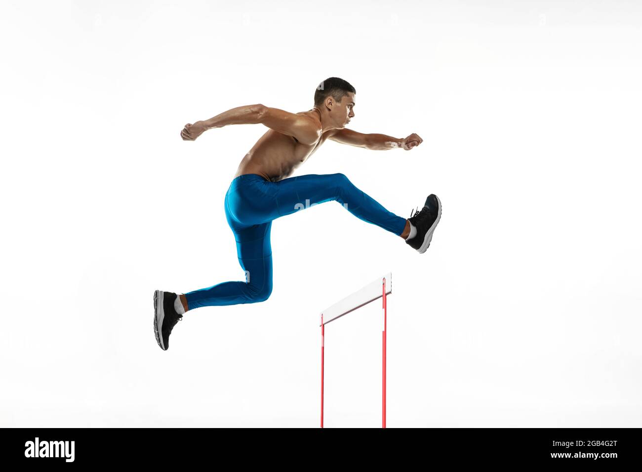 Steeplechase. Young male athlete, runner running, jumping isolated on ...