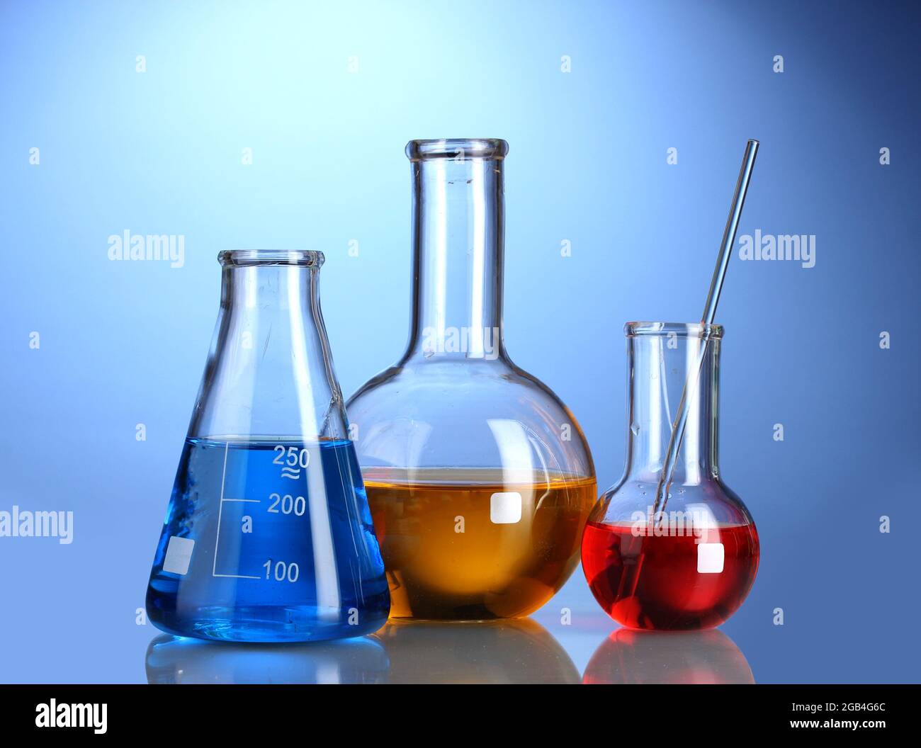 Three flasks with color liquid with reflection on blue background Stock ...