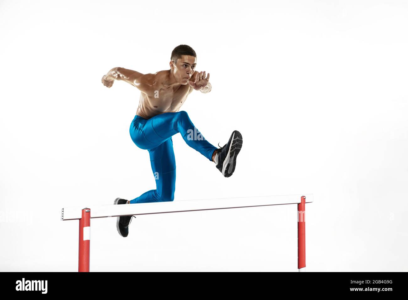 Steeplechase. Young male athlete, runner running, jumping isolated on ...