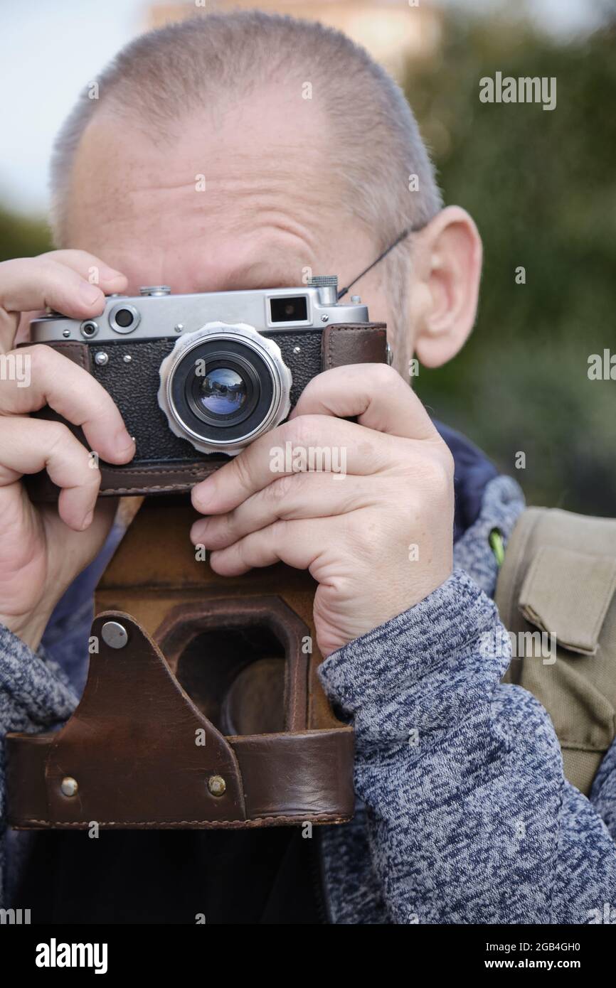 photographer with old style camera looking at camera taking shot Stock ...