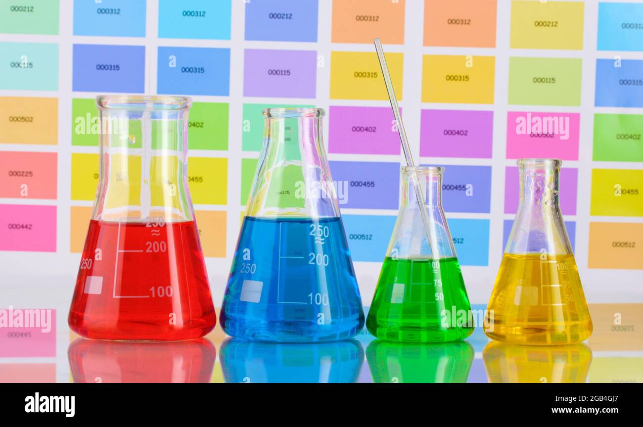 Laboratory flasks with color liquid on color samples background Stock ...