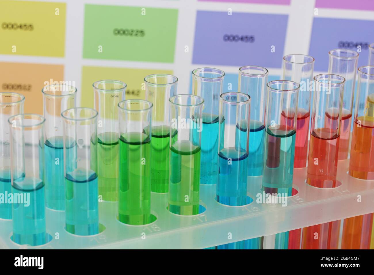 Test-tubes with color liquid on color samples background Stock Photo ...
