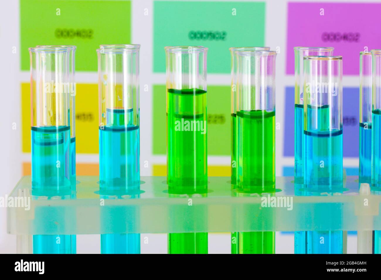 Test-tubes with color liquid on color samples background Stock Photo ...