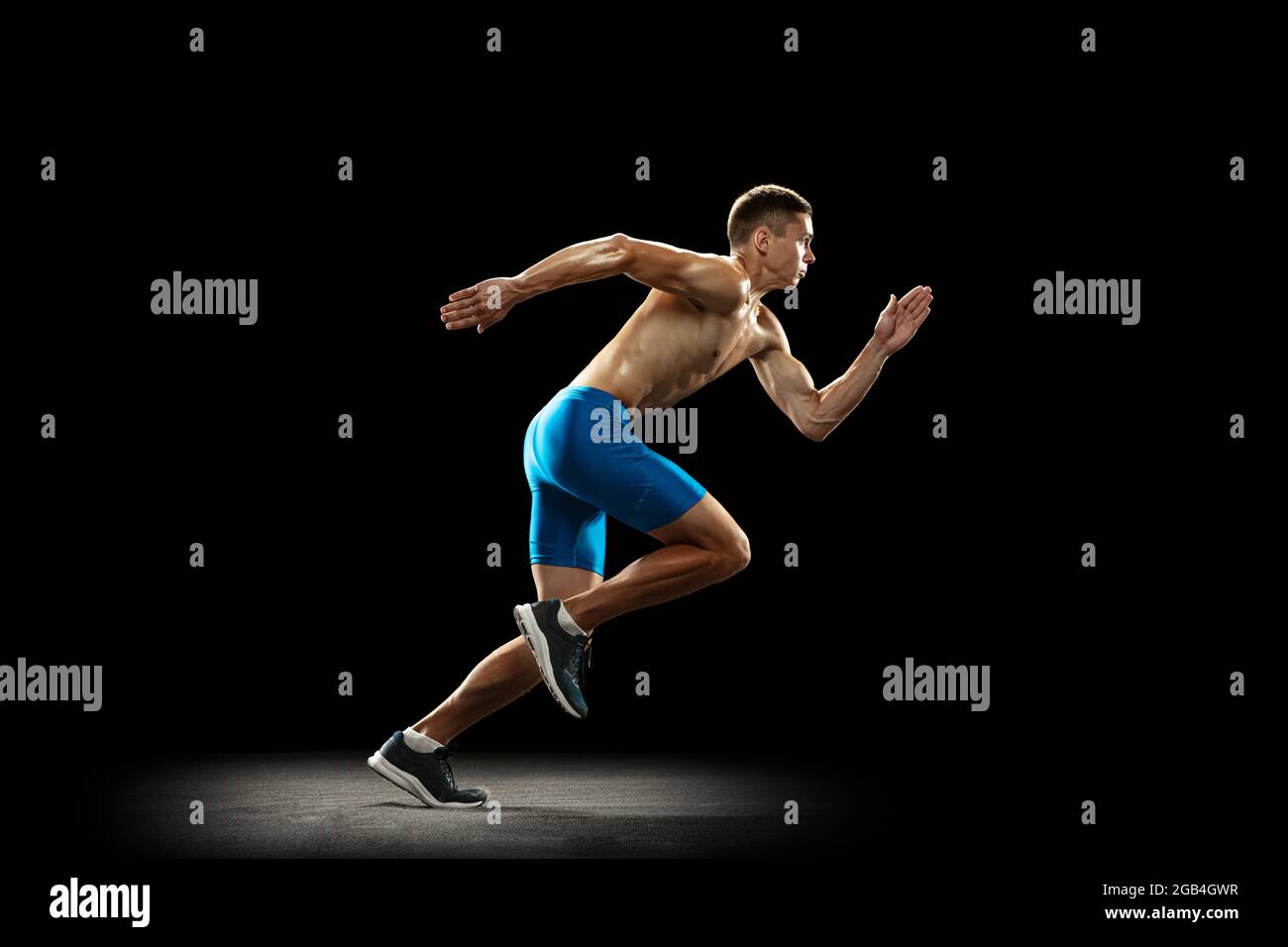 One Caucasian professional male athlete, runner training isolated on ...